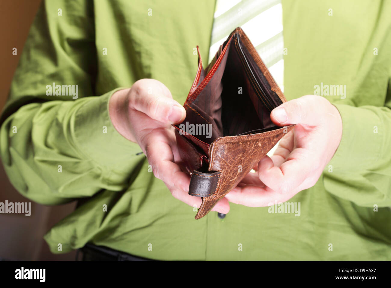 Poor economy represented by empty wallet in businessman's hands Stock ...