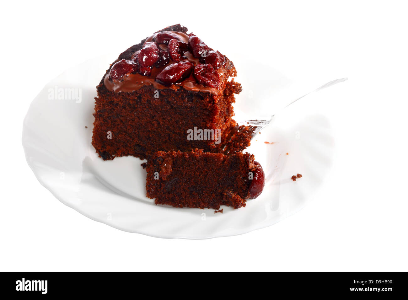Piece of chocolate cake with icing and cherry on white background Stock ...