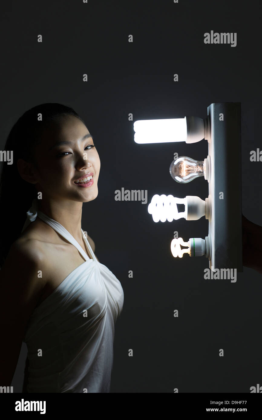 young woman with light bulbs Stock Photo - Alamy