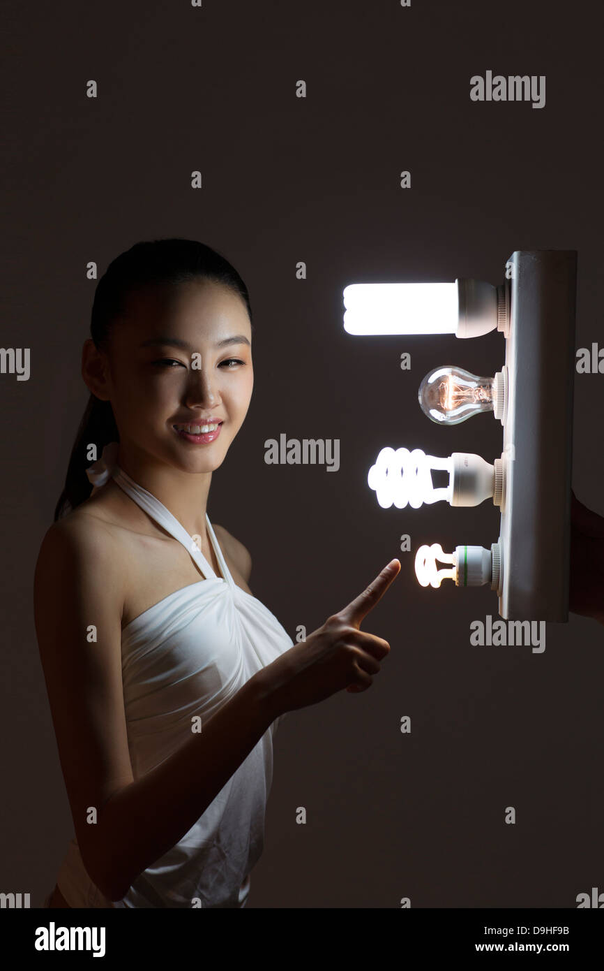 young woman with light bulbs Stock Photo - Alamy