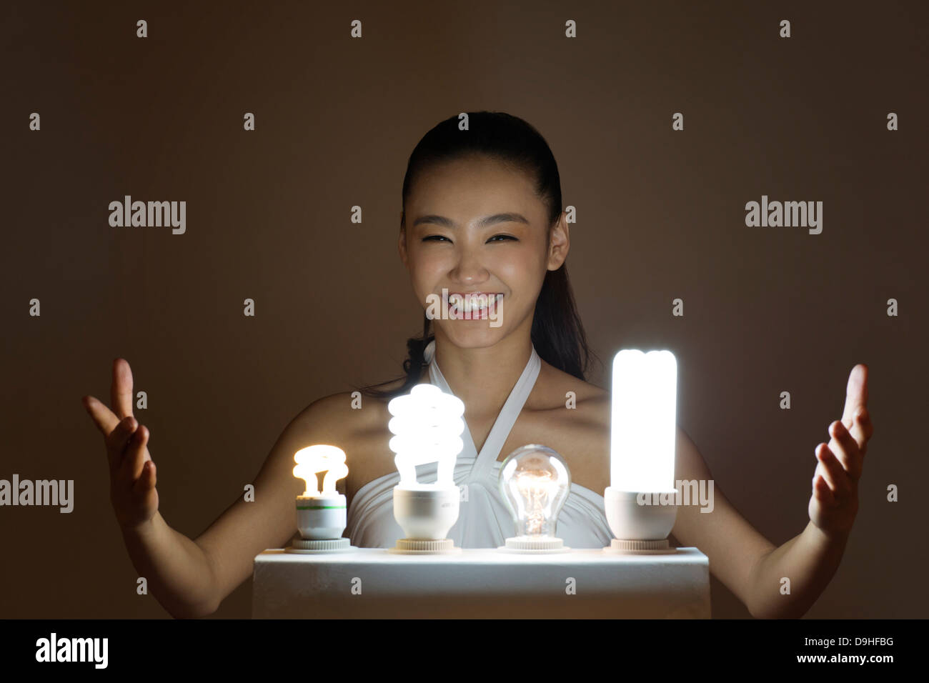 young woman with light bulbs Stock Photo - Alamy