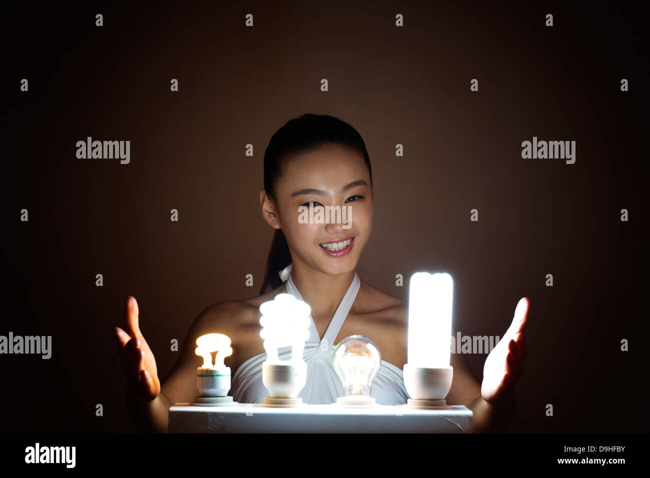 young woman with light bulbs Stock Photo - Alamy
