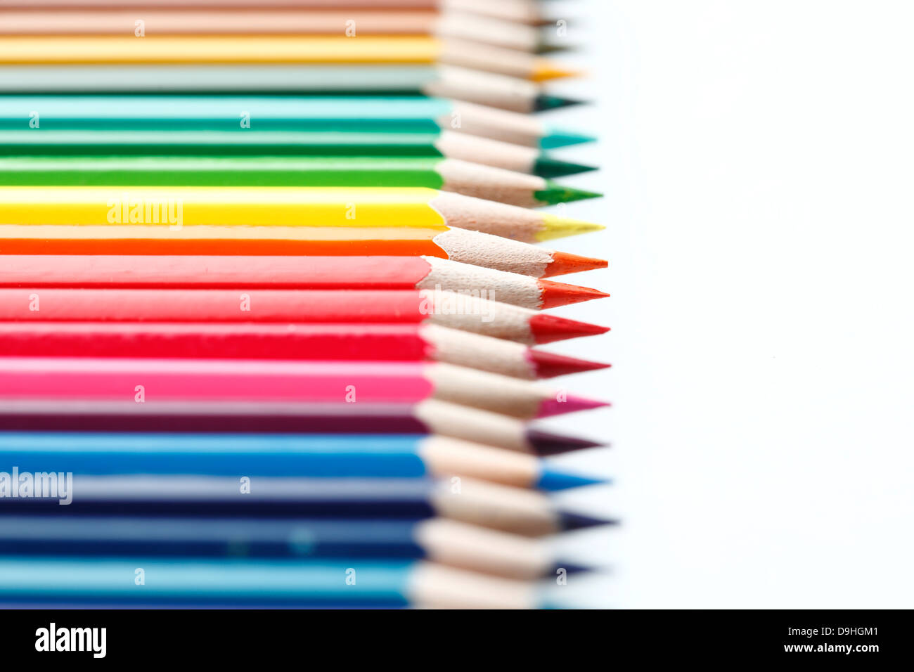 Colored pencils arranged horizontally in a row Stock Photo - Alamy