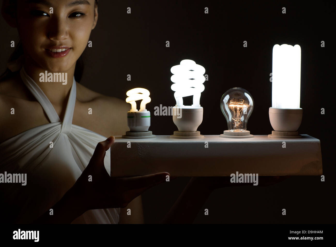 young woman with light bulbs Stock Photo - Alamy