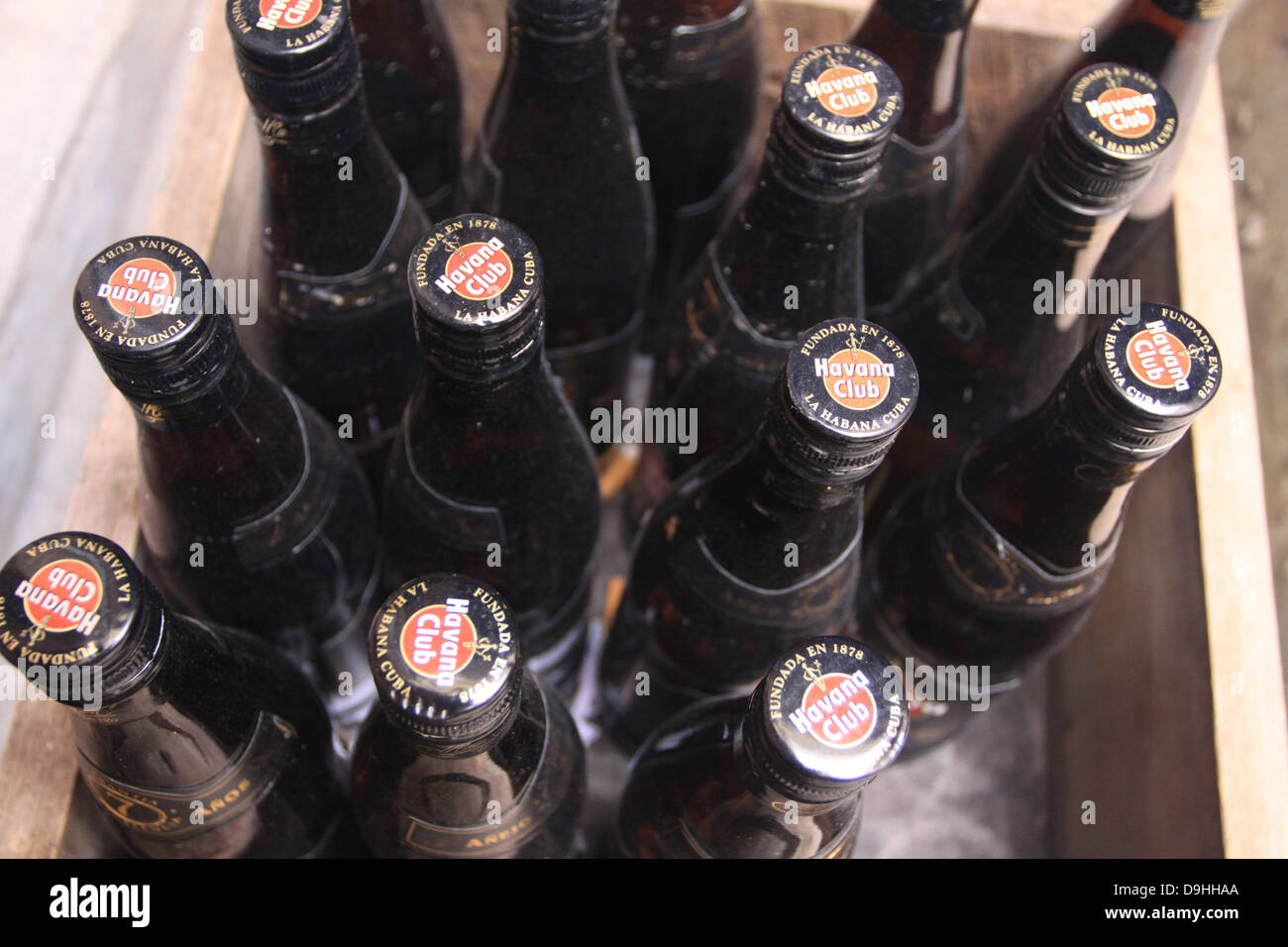 Empty bottles of rum of the brand 'Havanna Club' stand in a wooden ...