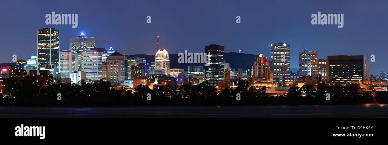 Montreal over river panorama at dusk with city lights and urban ...