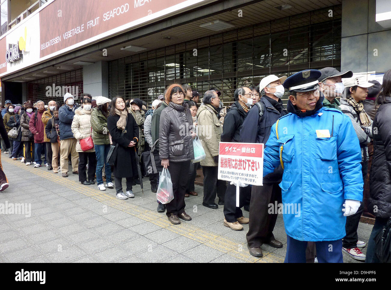 People line up in front of a supermarket in Sendai, in Miyagi ...