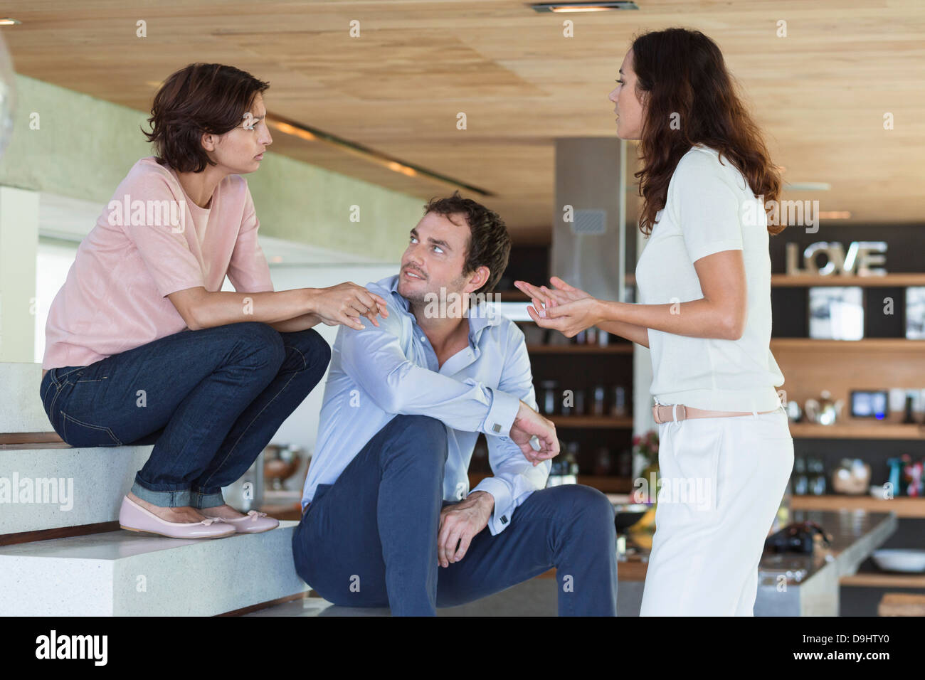 Friends arguing to each other at home Stock Photo - Alamy