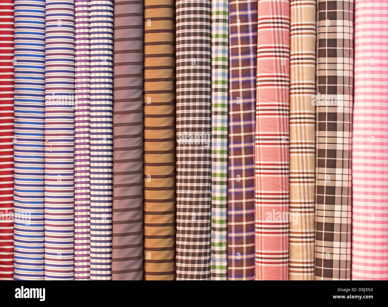 Rainbow clothes background. Pile of bright folded clothes Stock Photo ...