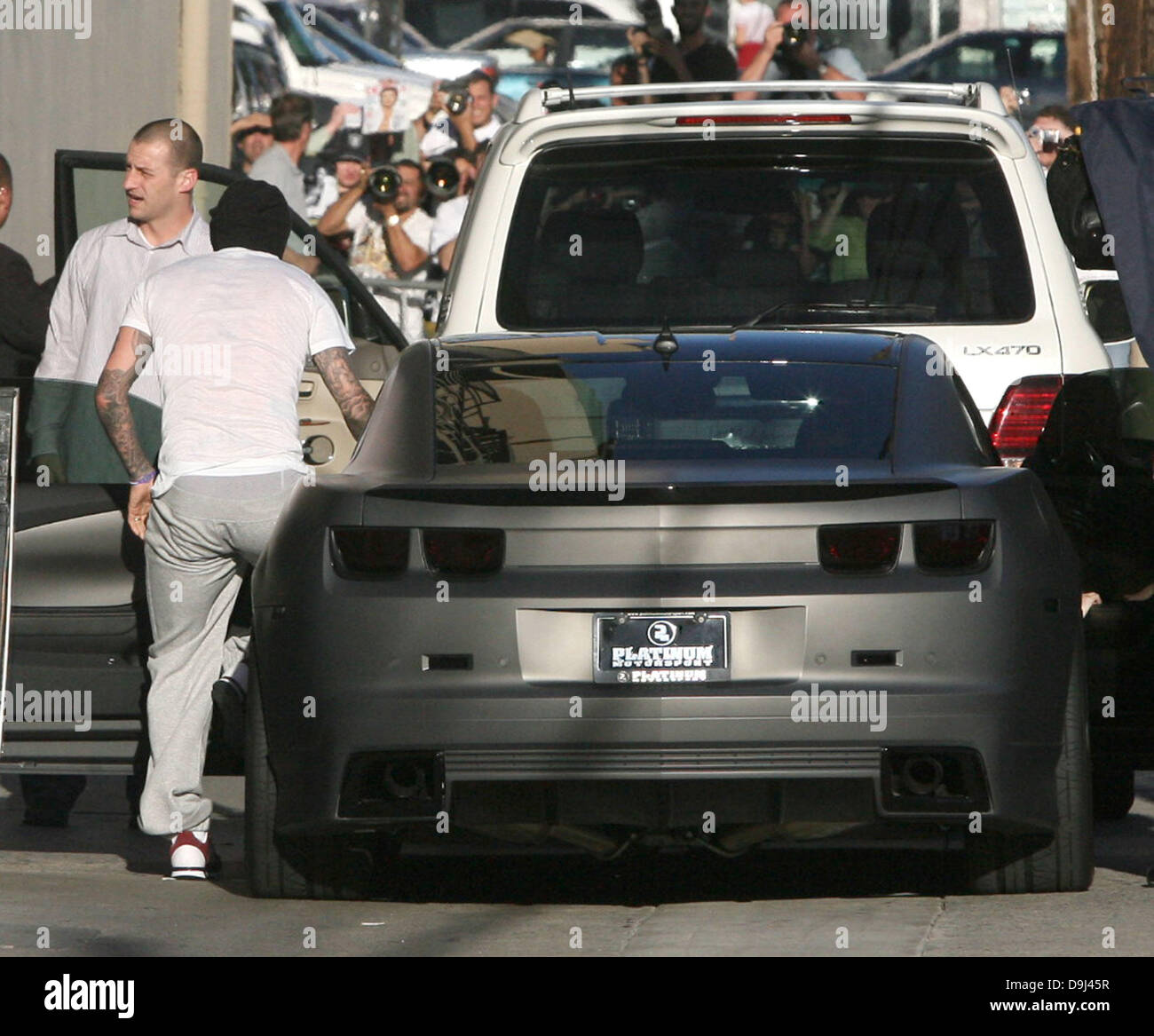 David Beckham hunches over his Platinum Motorsport sports car as he ...