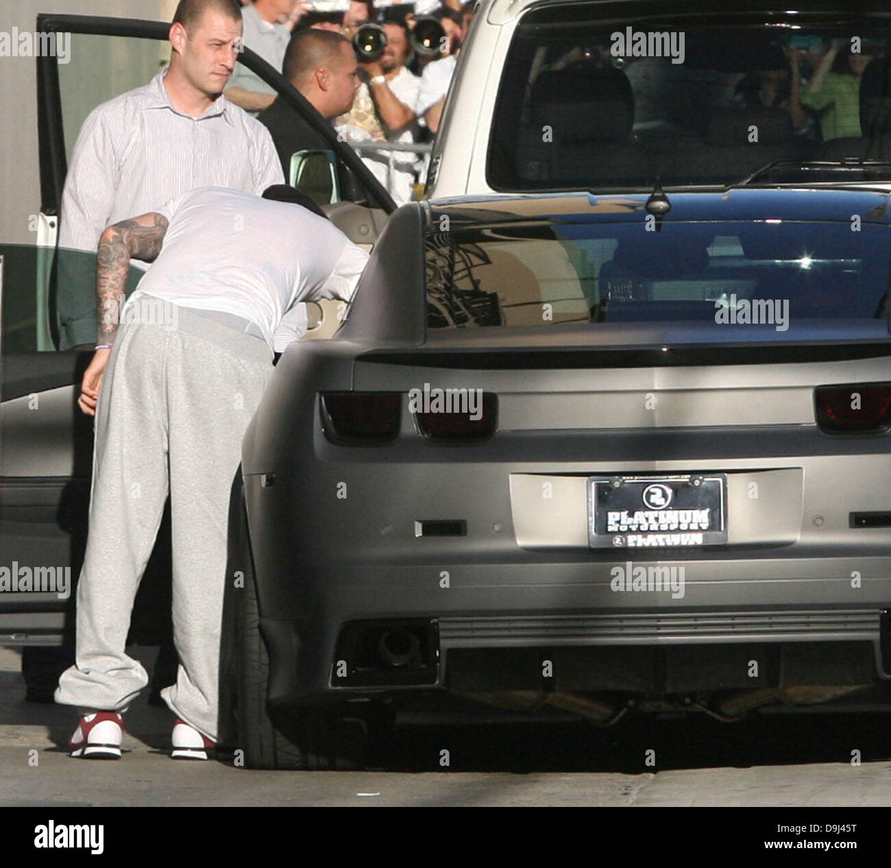 David Beckham hunches over his Platinum Motorsport sports car as he ...