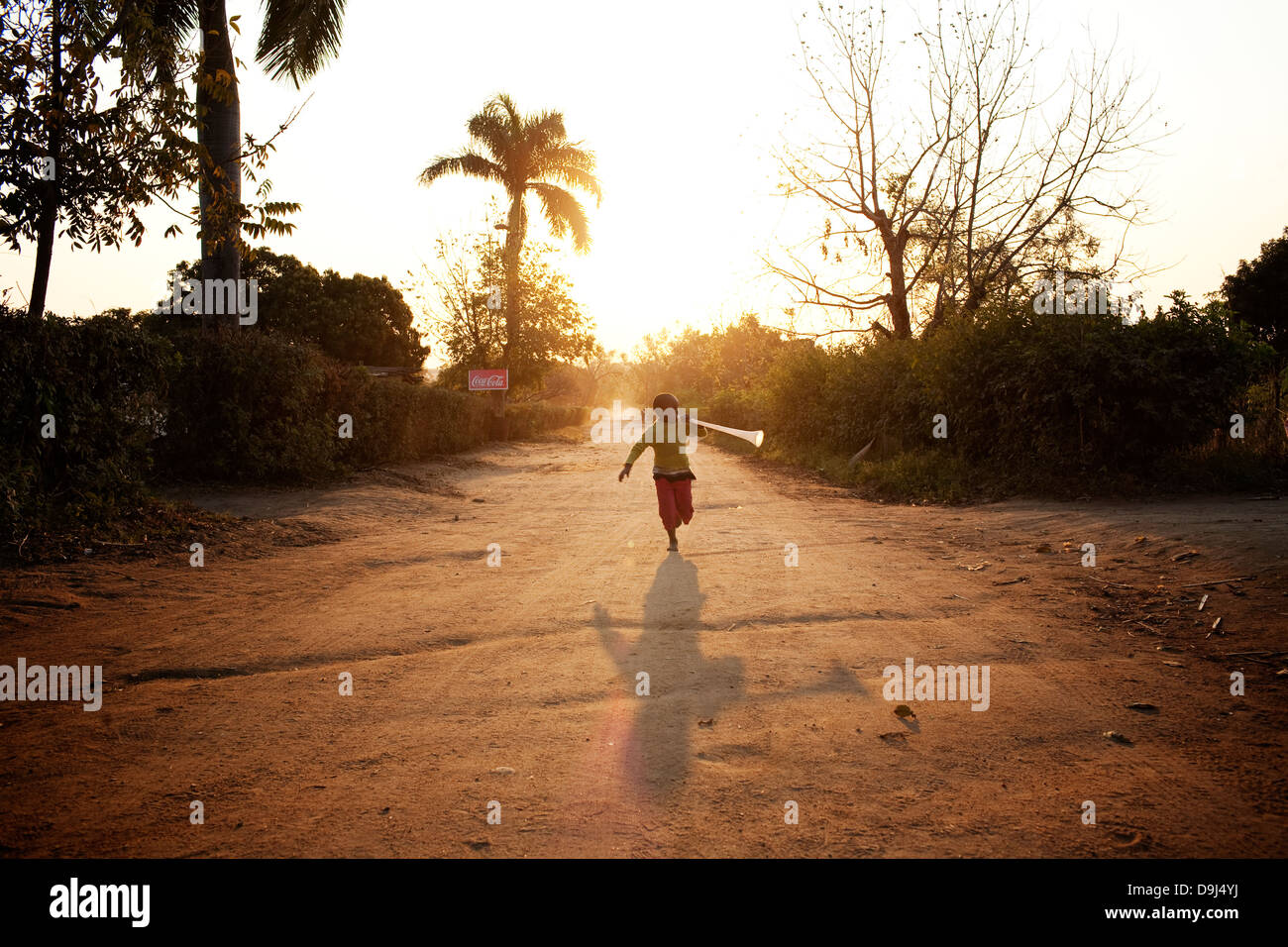 A young boy runs while blowing his vuvuzela through Mataffin village in ...