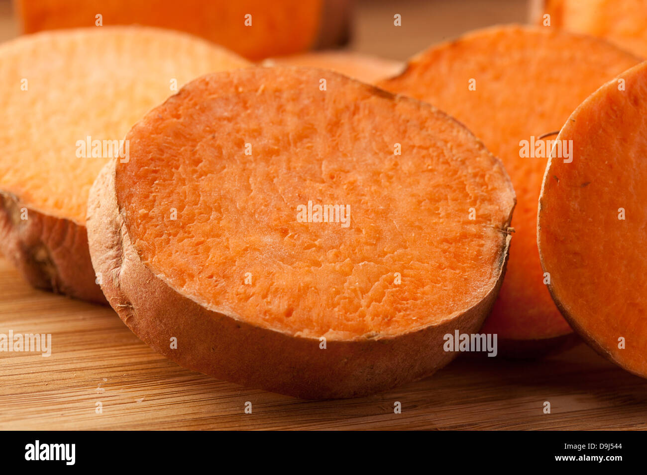 Fresh Organic Orange Sweet Potato against a background Stock Photo - Alamy