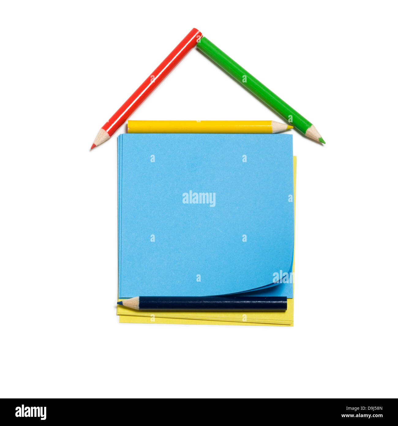 House made of colorful pencils and paper notes on white background ...