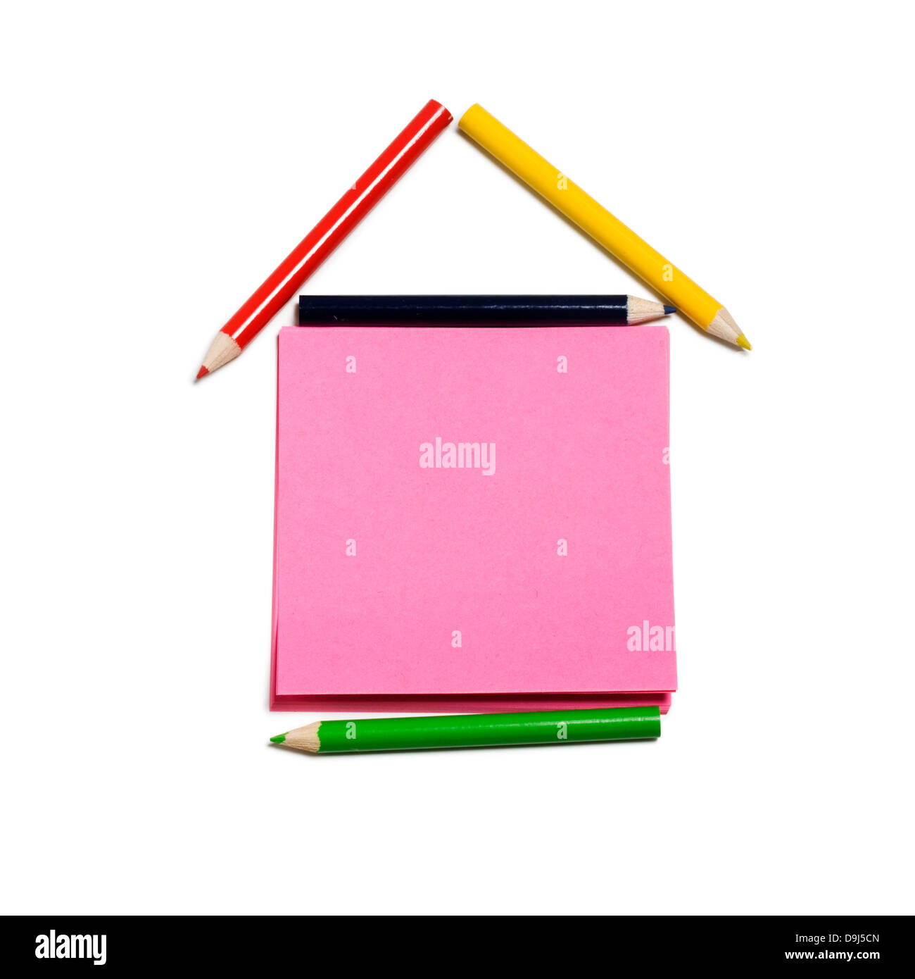 House made of colorful pencils and paper notes on white background ...