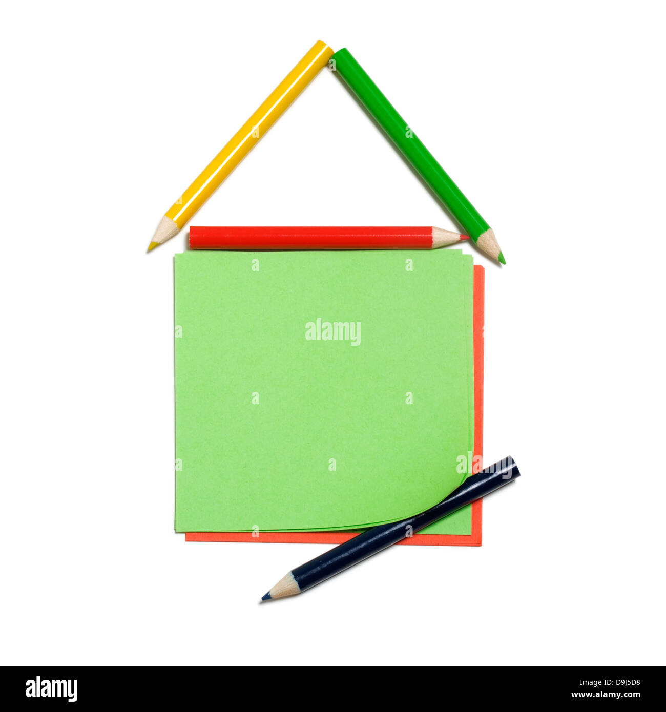 House made of colorful pencils and paper notes on white background ...