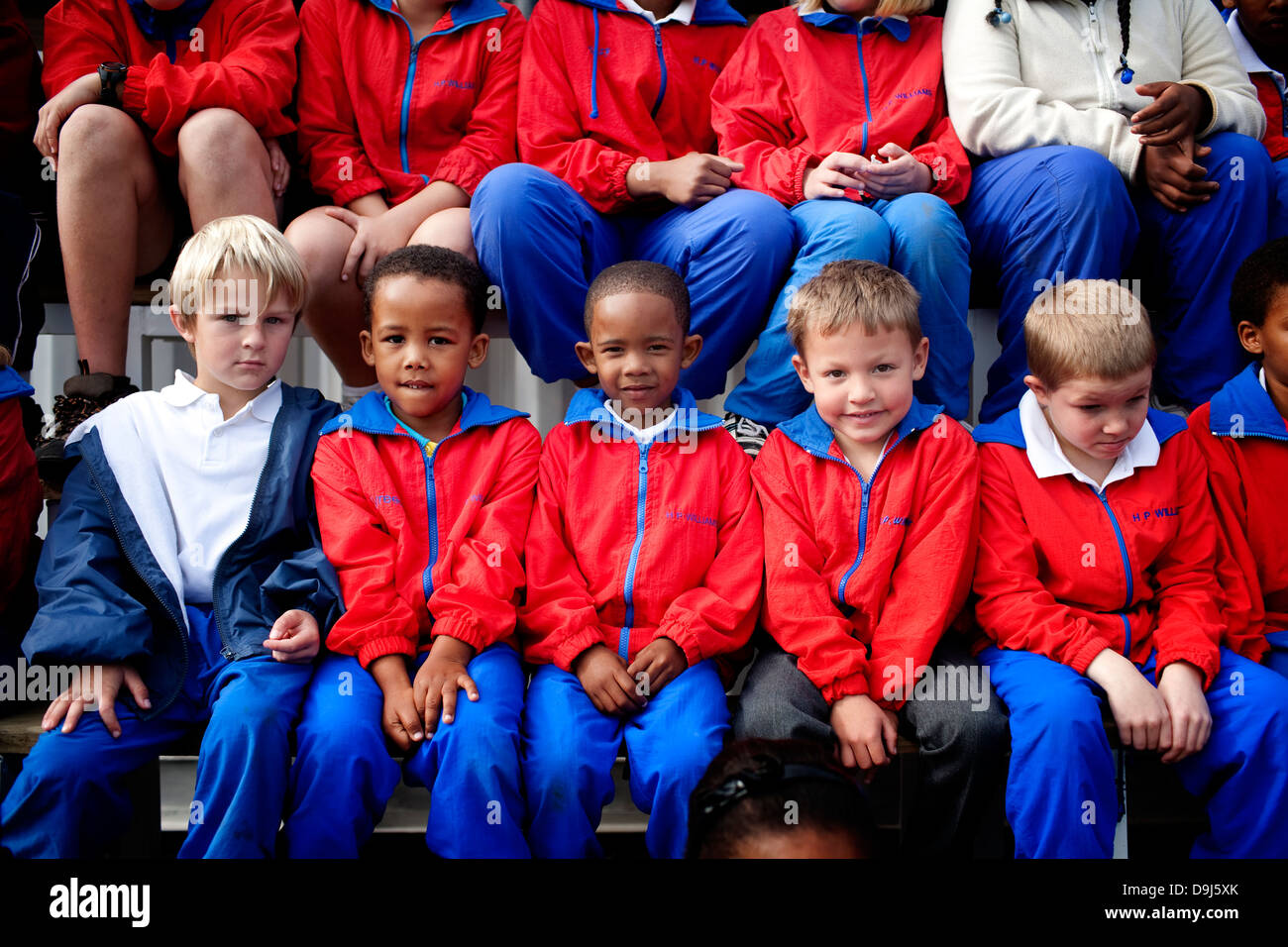 A group young school children H P Williams school sit on football stand ...