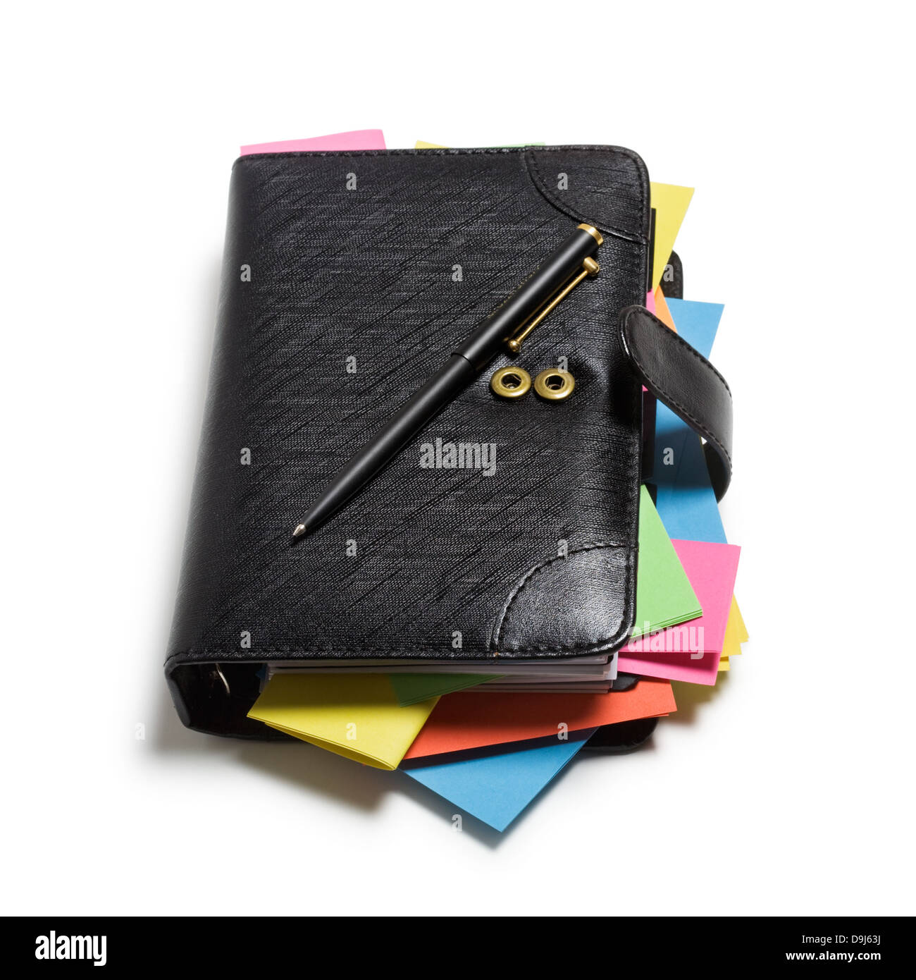 Black notebook with colorful note papers and pen on white background ...