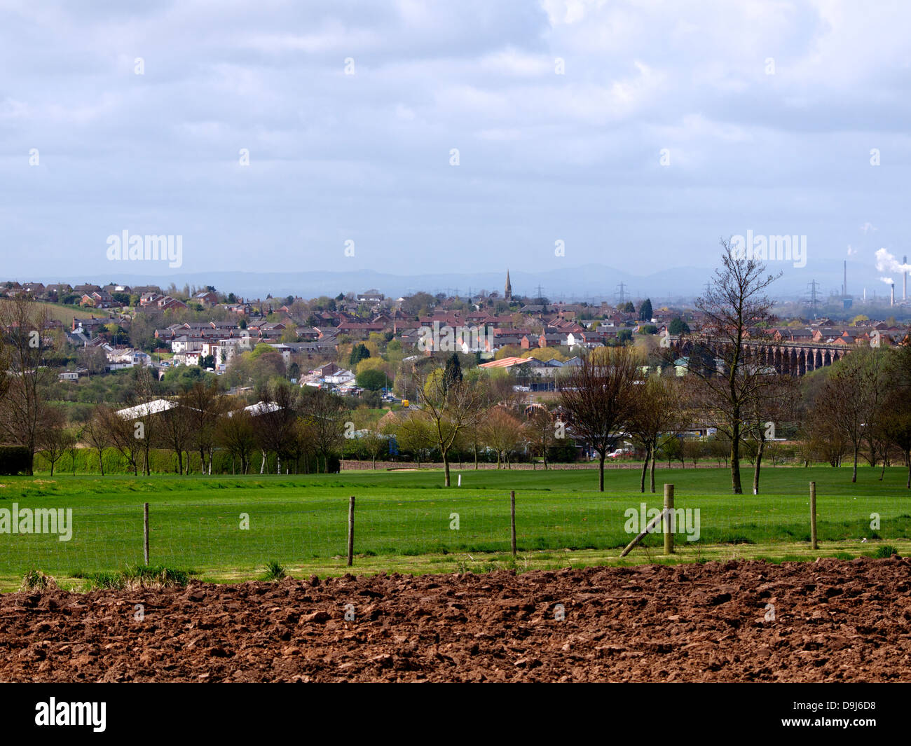 Farmers field and a village in the background Stock Photo - Alamy