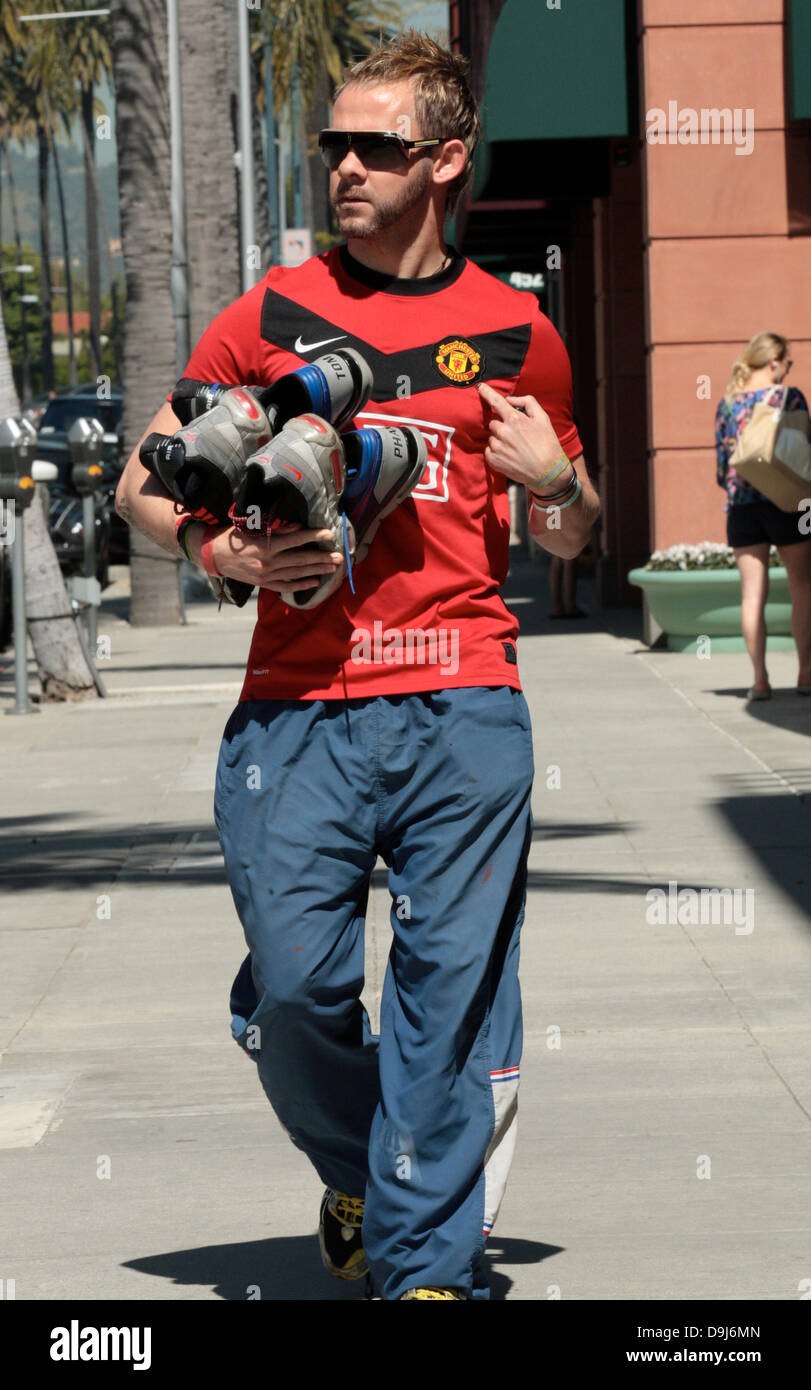 Dominic Monaghan proudly wears his Manchester United shirts as he takes ...