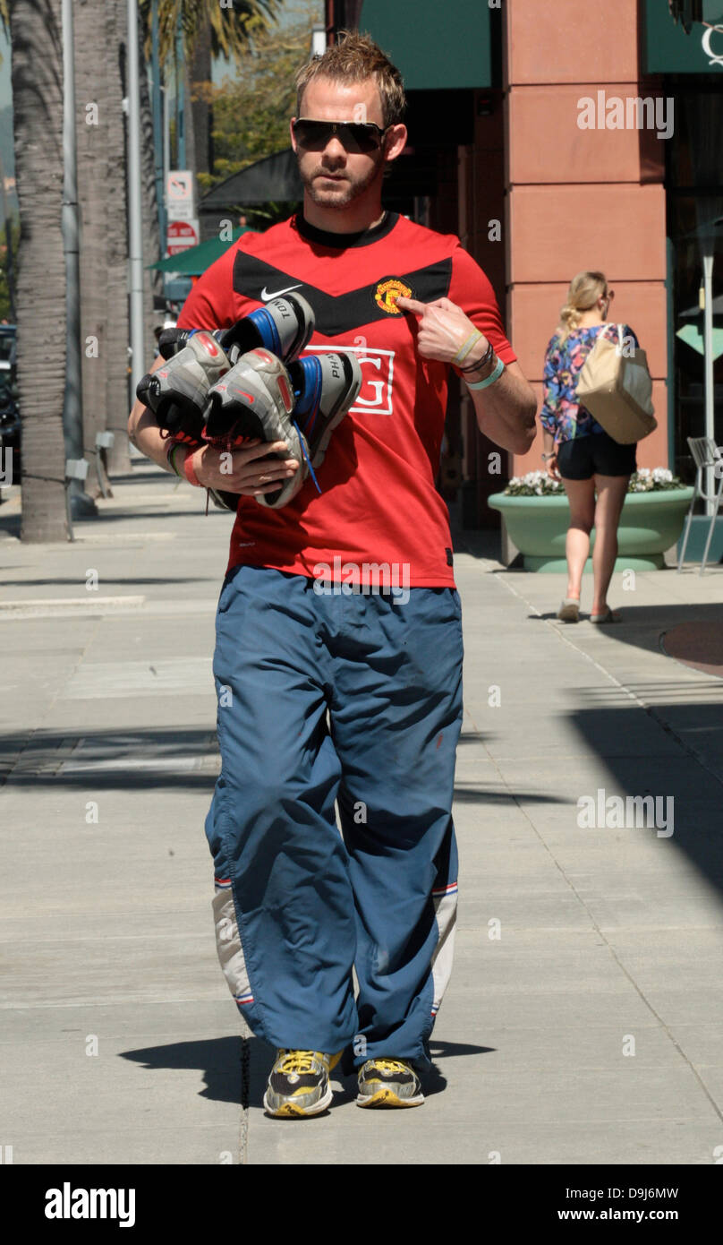 Dominic Monaghan proudly wears his Manchester United shirts as he takes ...