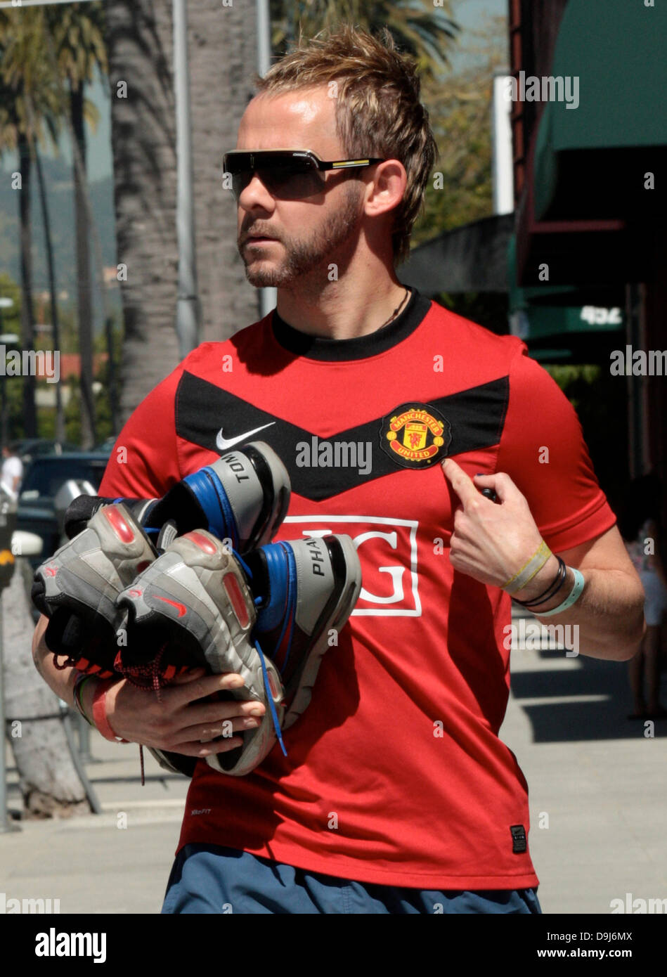 Dominic Monaghan proudly wears his Manchester United shirts as he takes ...