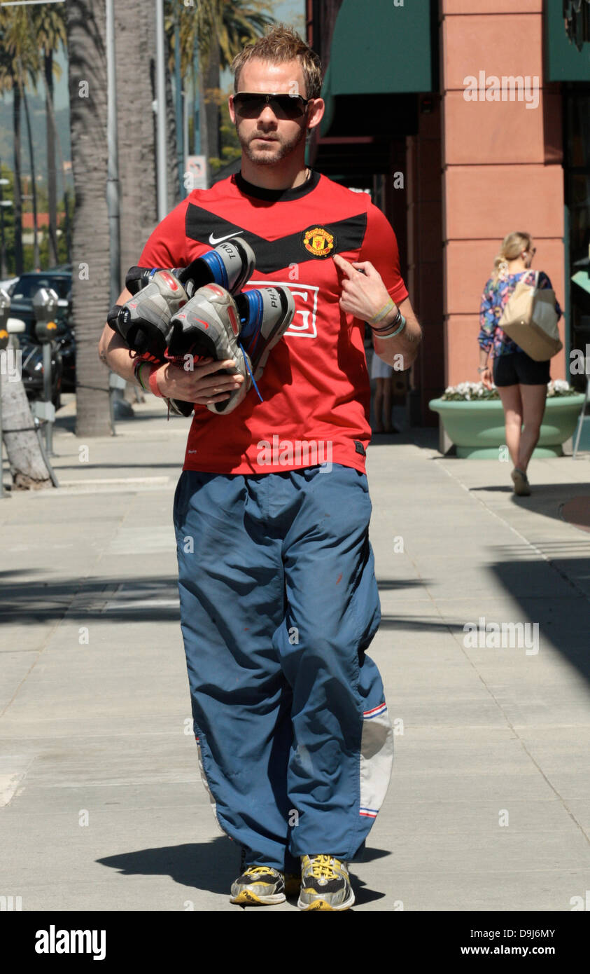 Dominic Monaghan proudly wears his Manchester United shirts as he takes ...