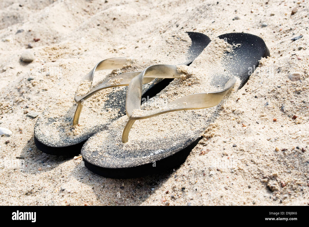 Flip flops in the sand Stock Photo - Alamy