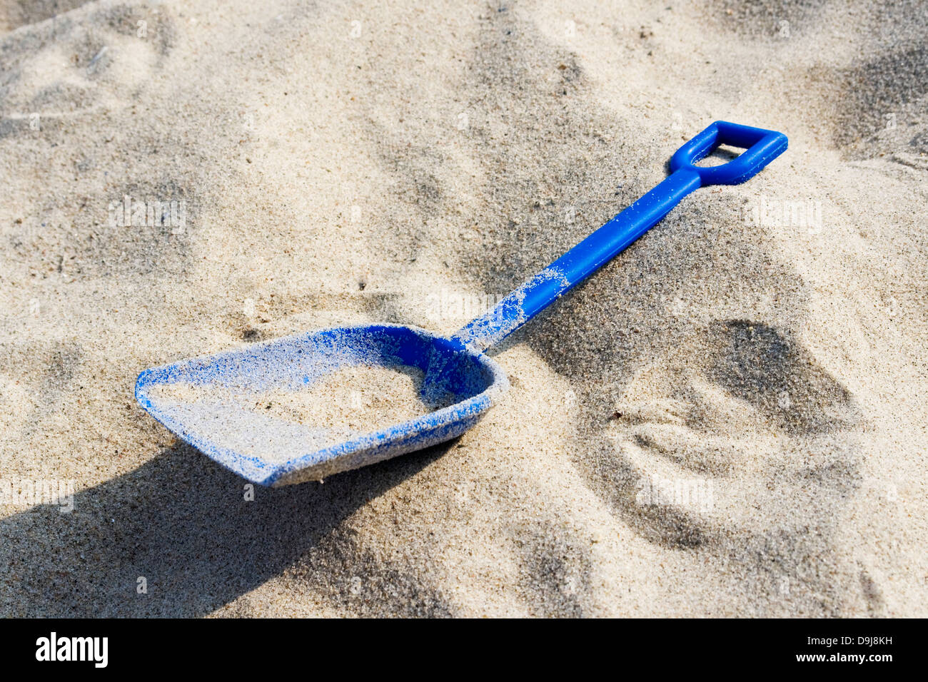 Shovel in the sand Stock Photo - Alamy