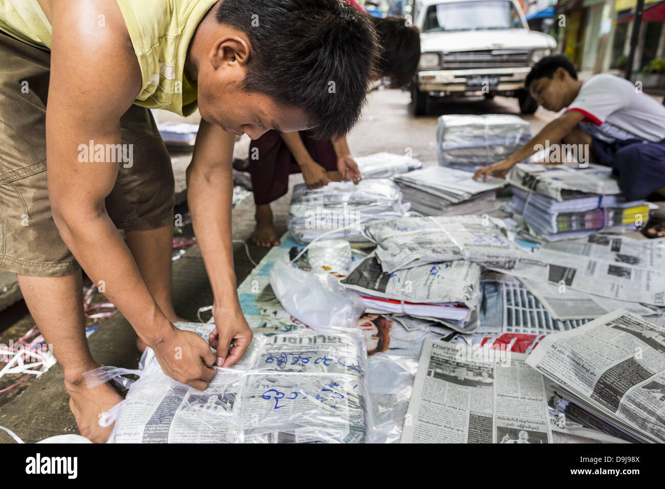 June 18, 2013 - Yangon, Union of Myanmar - Newspapers are bundled for ...