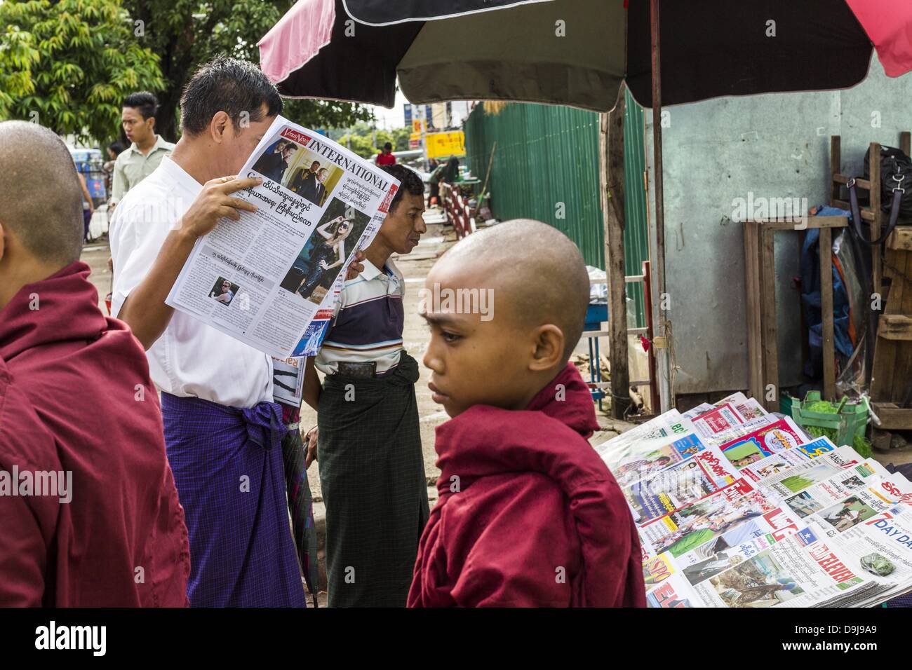 June 18, 2013 - Yangon, Union of Myanmar - A Burmese man reads the ...