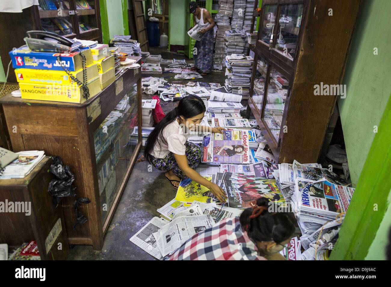 June 18, 2013 - Yangon, Union of Myanmar - Newspapers are bundled for ...