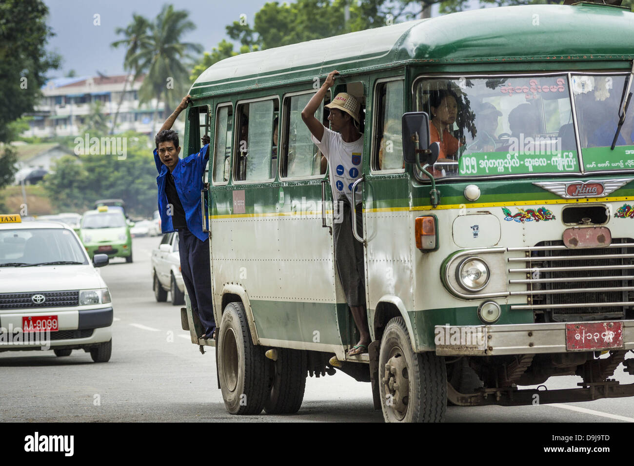 June 19, 2013 - Yangon, Union of Myanmar - Conductors lean out the ...