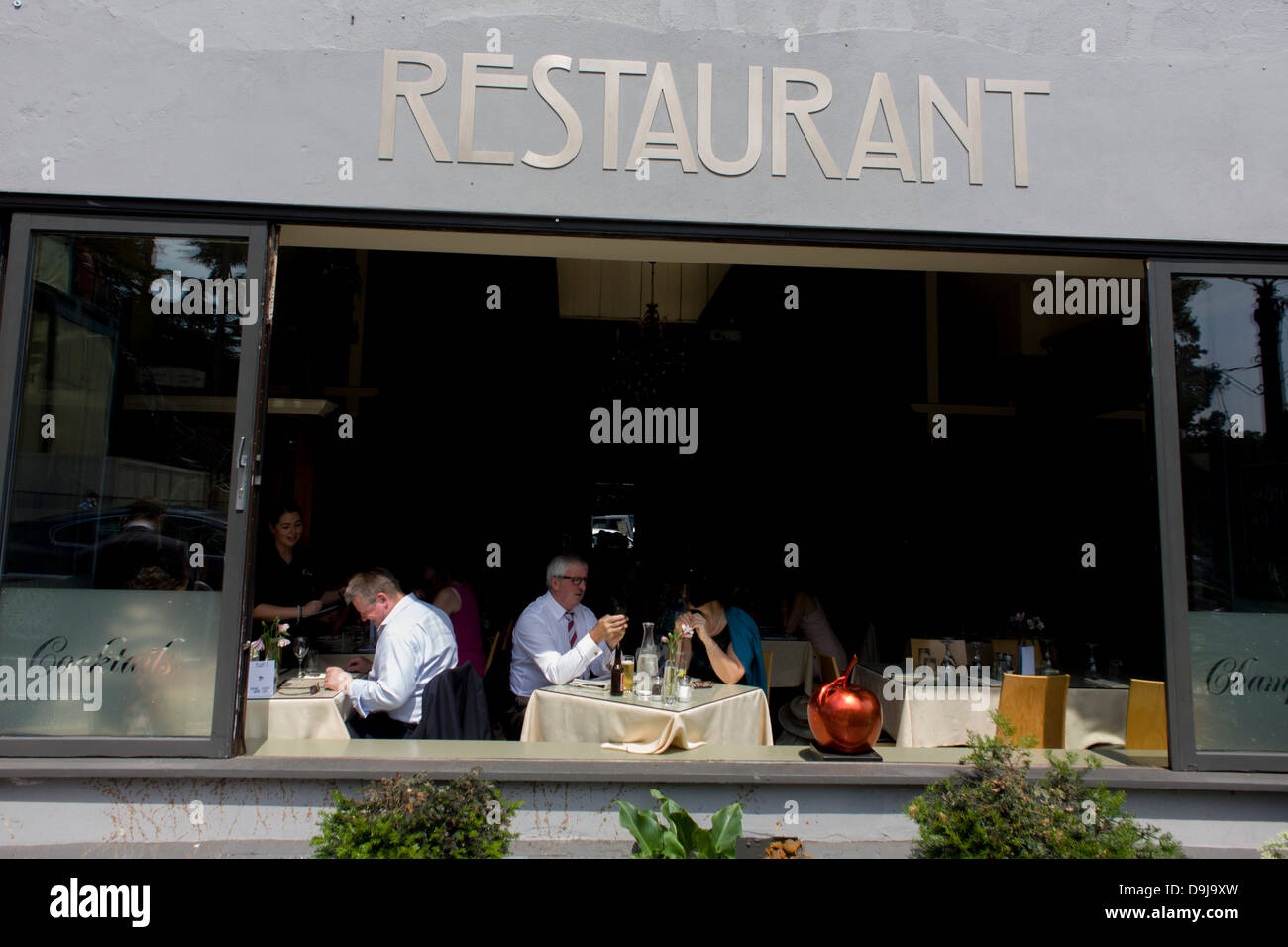 Customers enjoy fresh air in seats of a generic restaurant with its ...