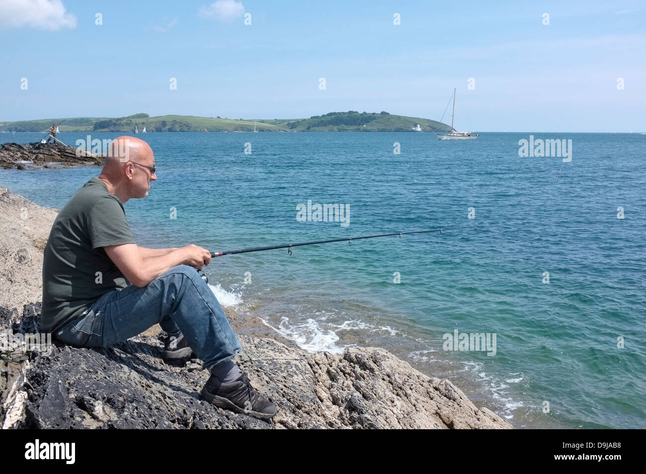 A man fishing from Pendennis Point in Falmouth, Cornwall Stock Photo ...