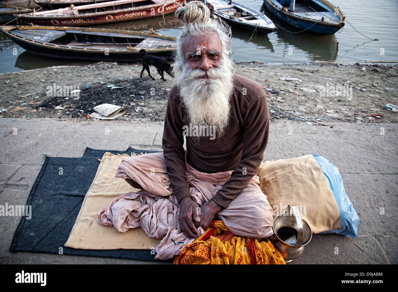 Portrait of a sadhu sitting at the Ganges riverbanks. Varanasi, Benares ...