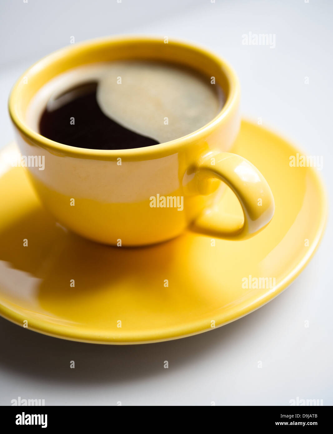 Coffee in an yellow cup Stock Photo - Alamy