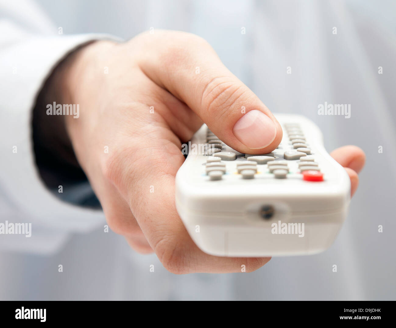 Tv remote control in hand Stock Photo - Alamy