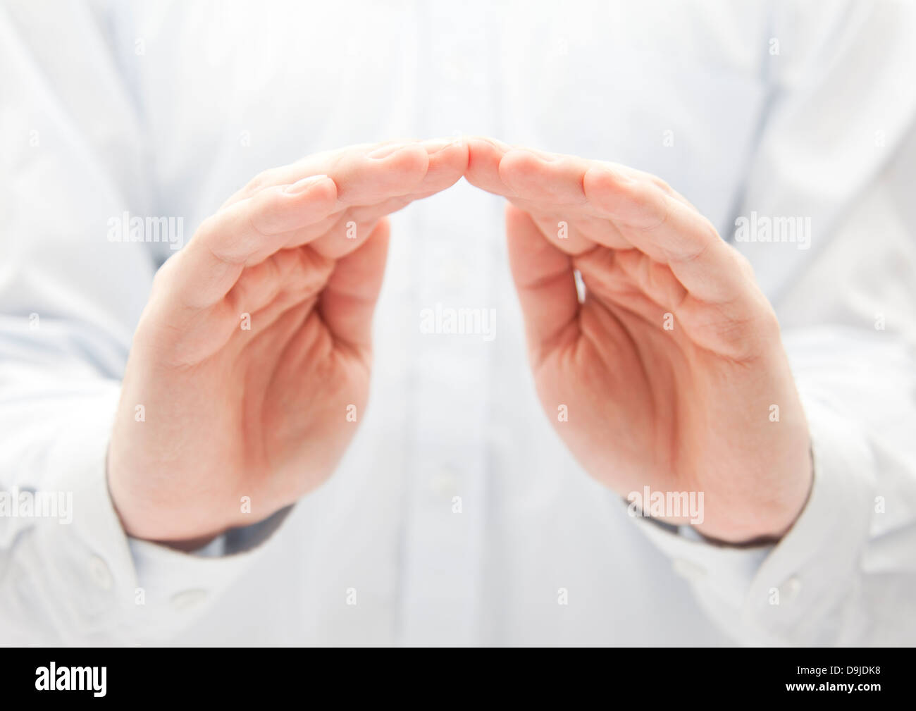 Protecting hands hi-res stock photography and images - Alamy
