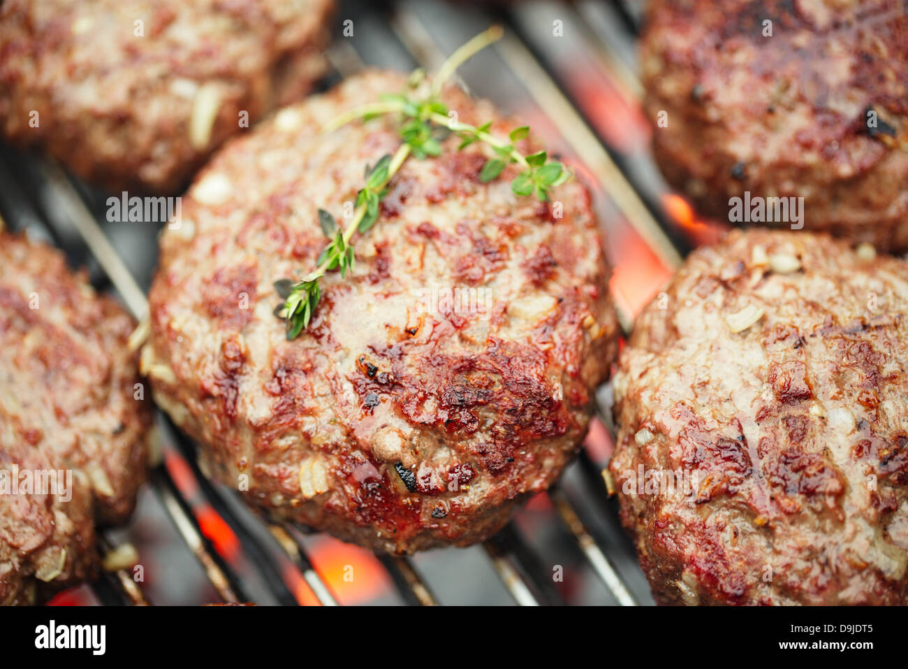 food meat - beef burgers on bbq barbecue grill with flame. Shallow dof ...