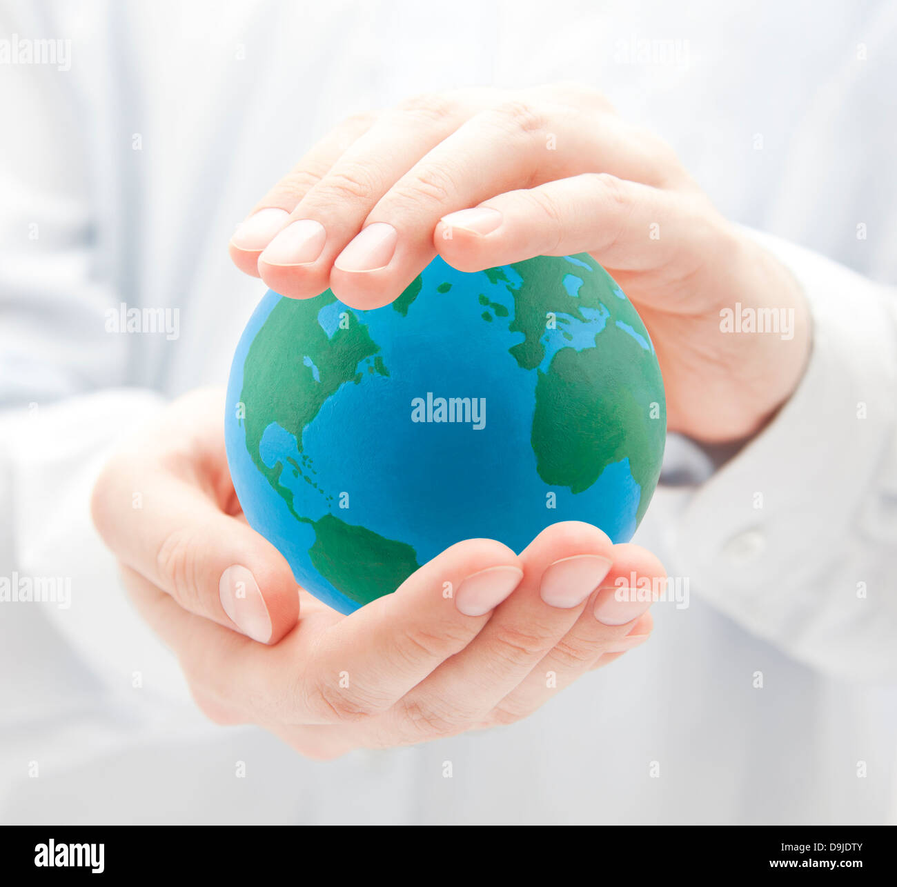 Globe in hands Stock Photo - Alamy