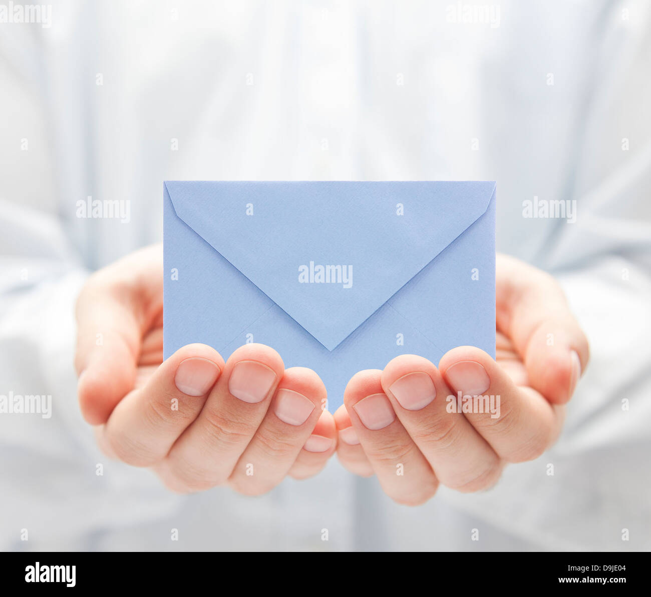 Blue paper envelope in hands Stock Photo - Alamy