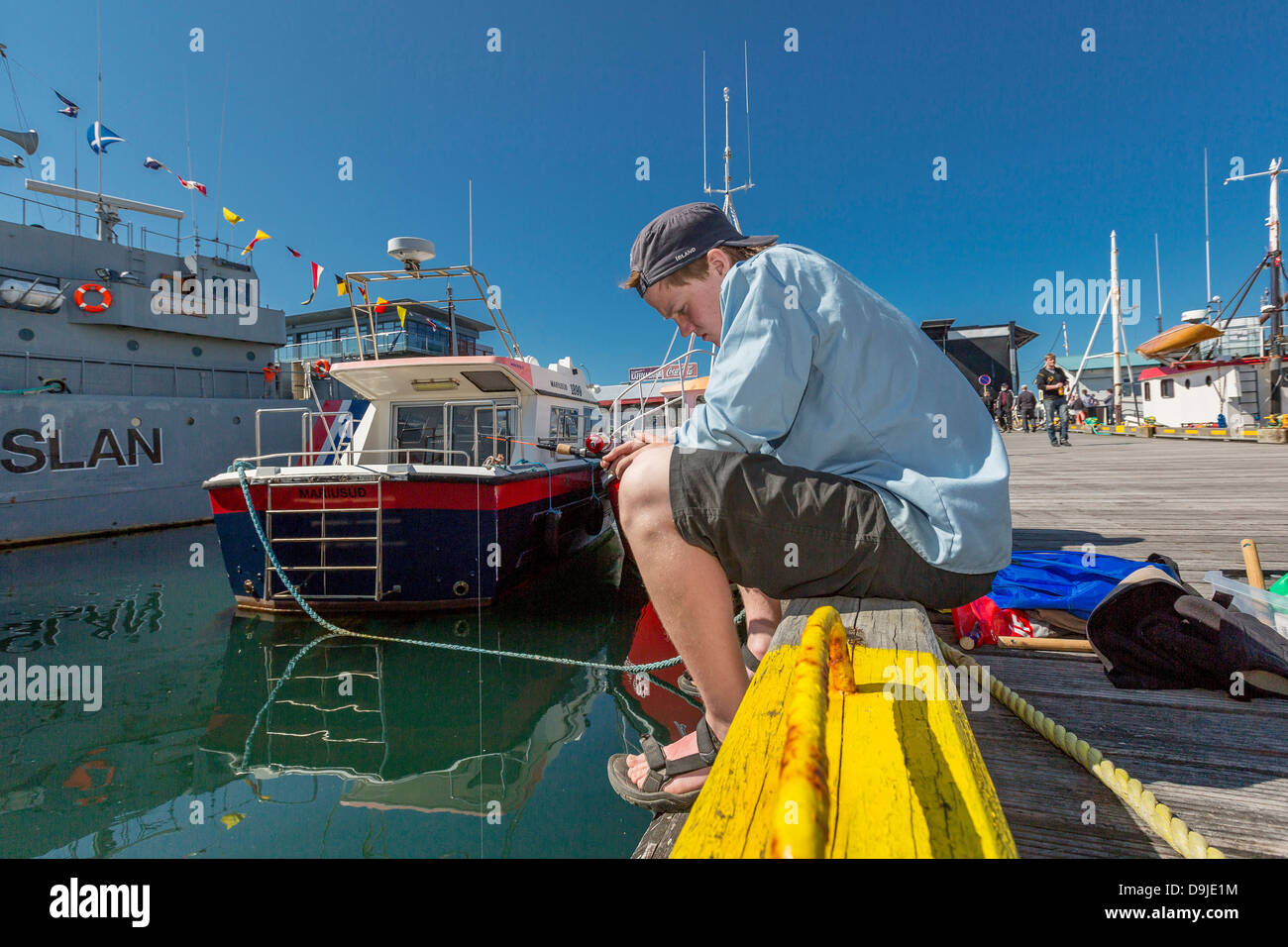 Teenager fishing on a dock, Reykjavik Harbor, Seaman's Day Festival ...