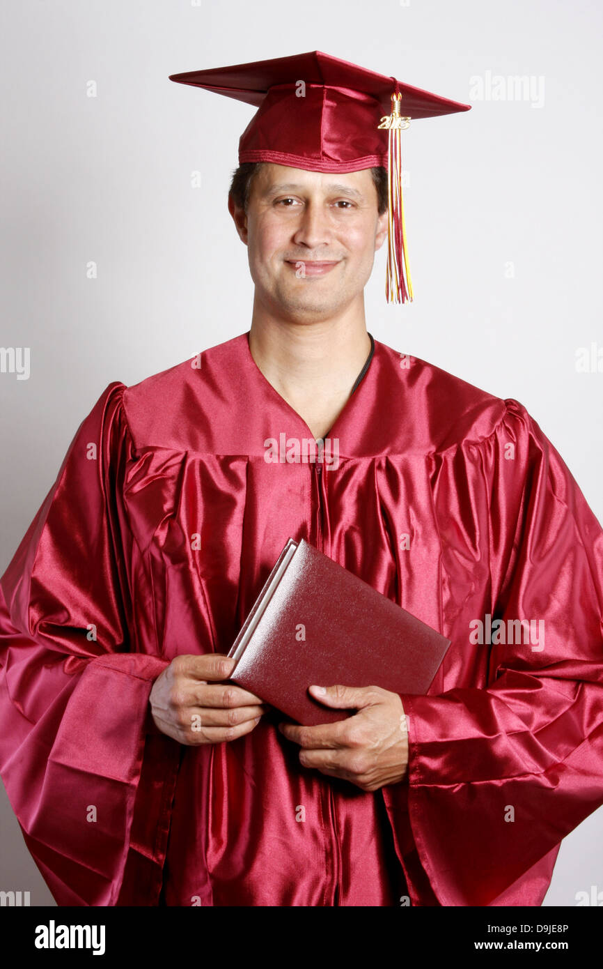 2013 Graduate in a red cap and gown with diploma Stock Photo - Alamy