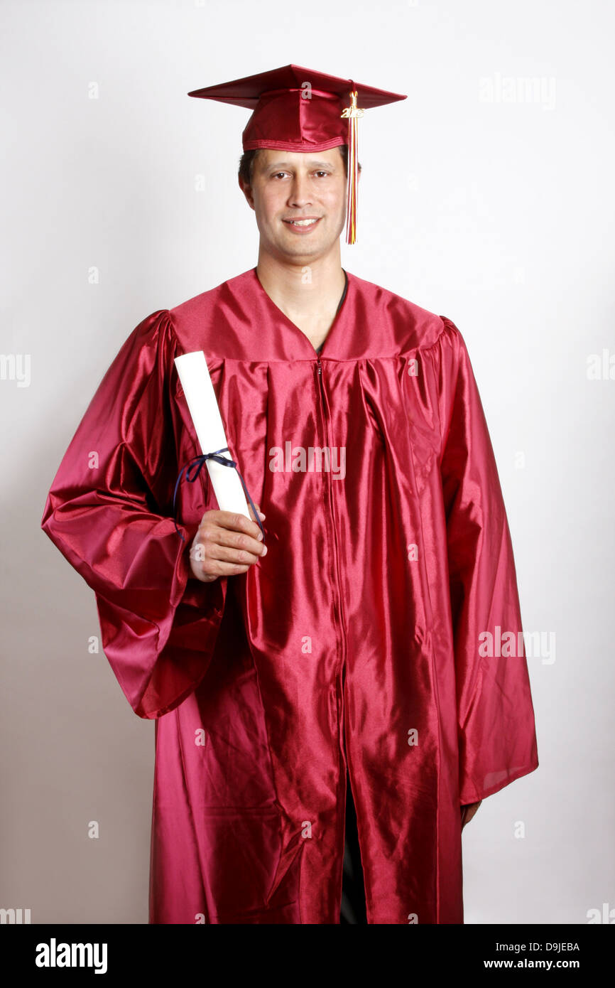 A 2013 graduate in a red cap and gown Stock Photo - Alamy