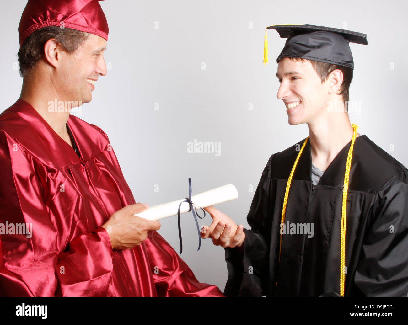 A Dean handing a graduate a diploma Stock Photo - Alamy