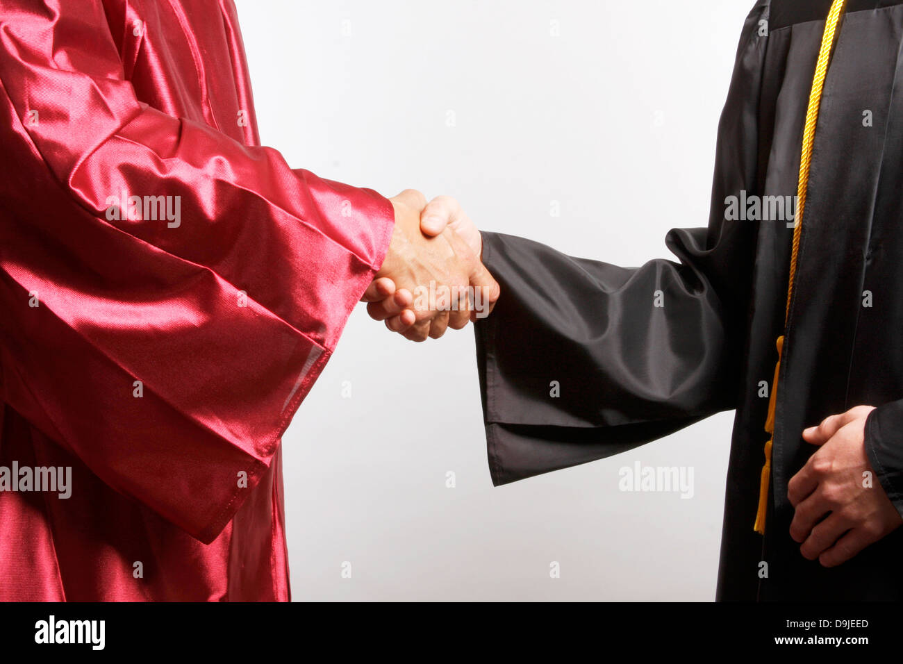 A Dean shaking hands with a graduate Stock Photo - Alamy