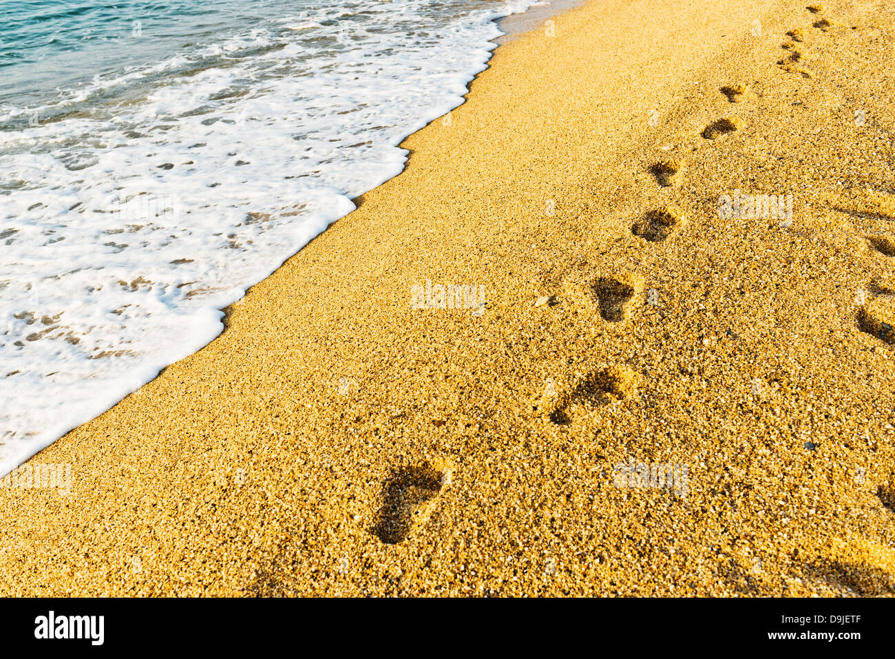 Footprint on sand with foam Stock Photo - Alamy