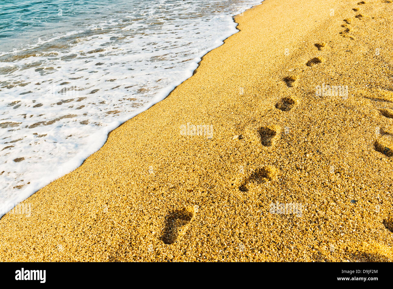 Footprint on sand with foam Stock Photo - Alamy