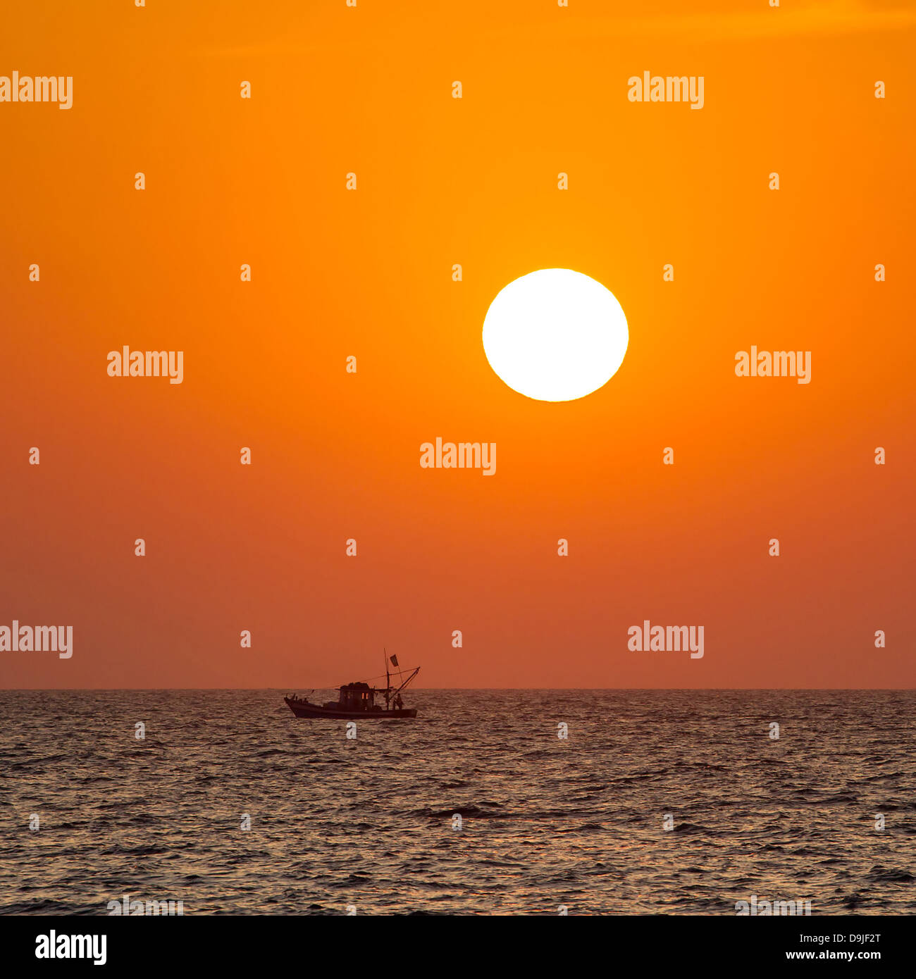 Sailing boat in the sea at sunset Stock Photo - Alamy